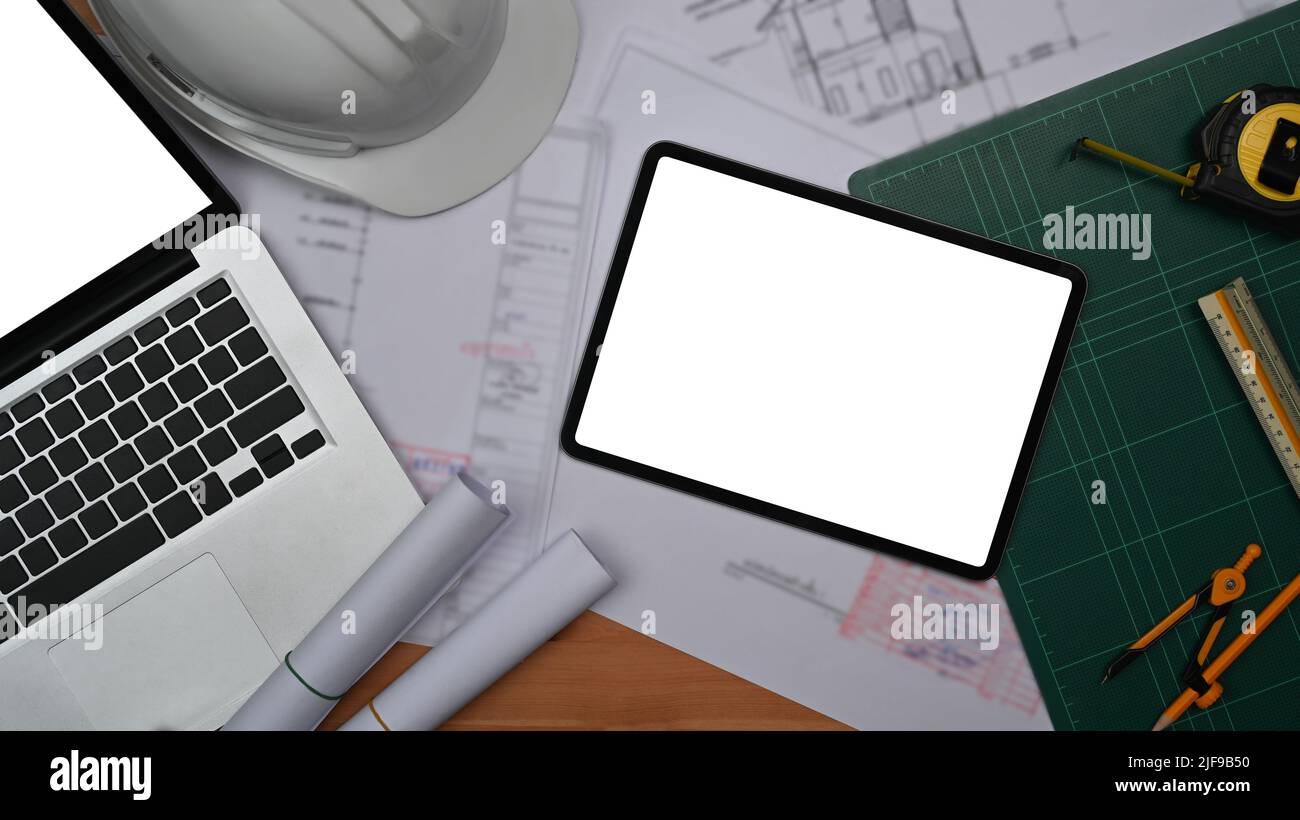 Architectural and Engineer office desk with laptop, digital tablet ...