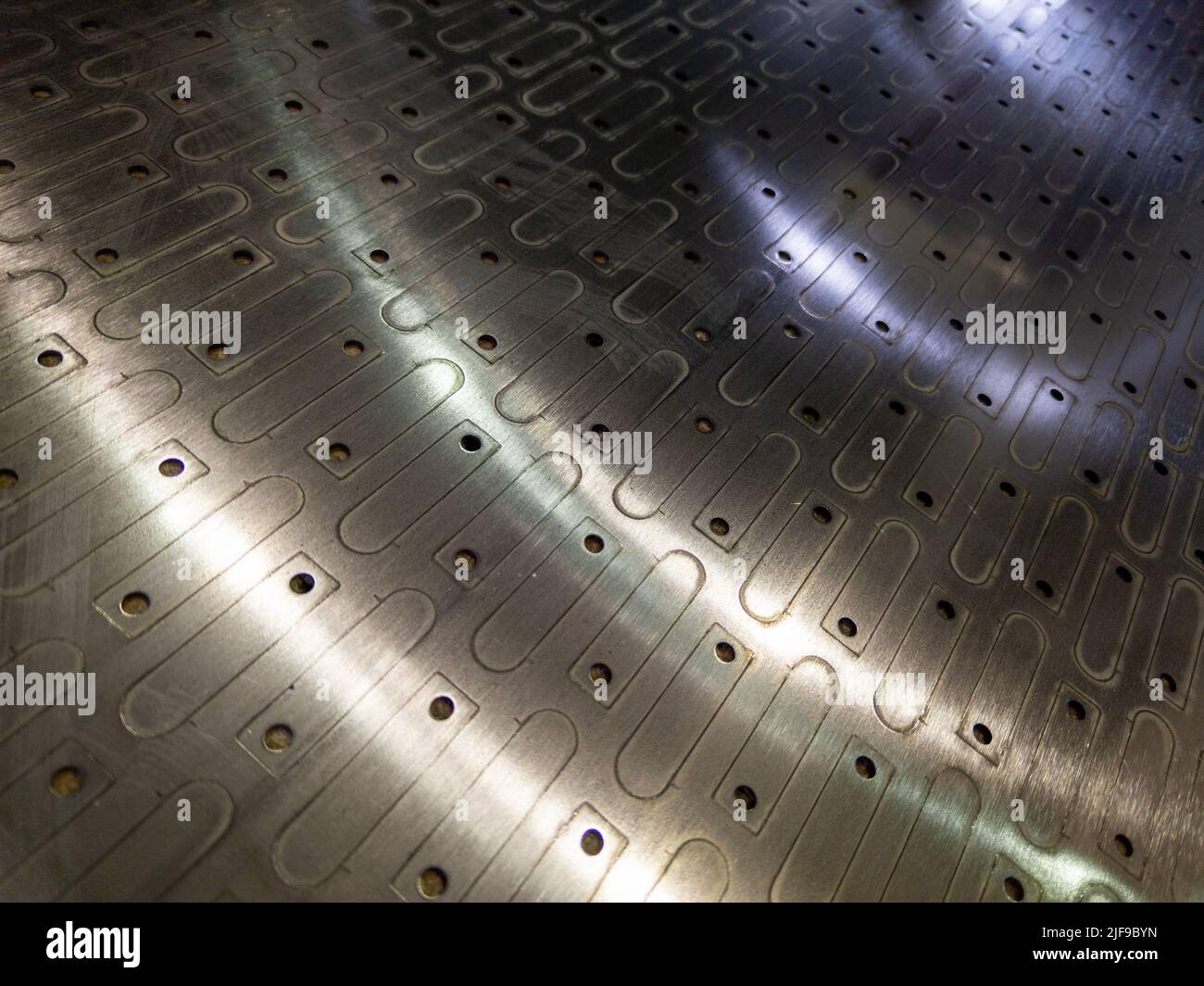 brushed stainless steel sheet with laser cutted parts Stock Photo - Alamy