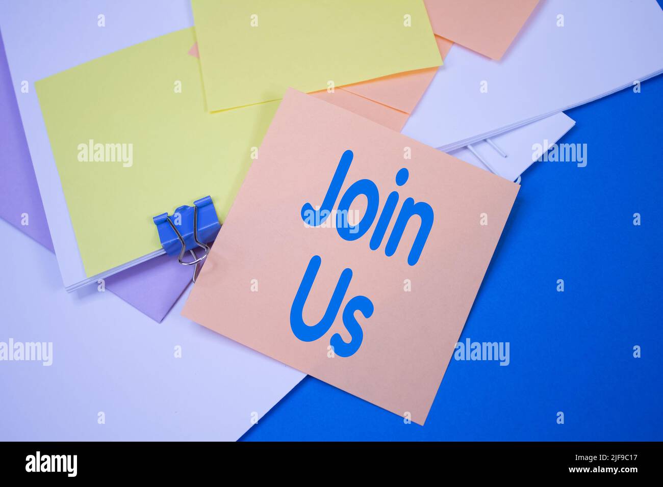 Join Us. Text on adhesive note paper. Event, celebration reminder ...