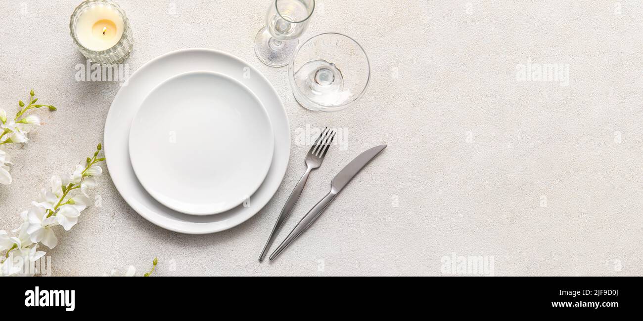 Beautiful table setting with floral decor on light background with ...