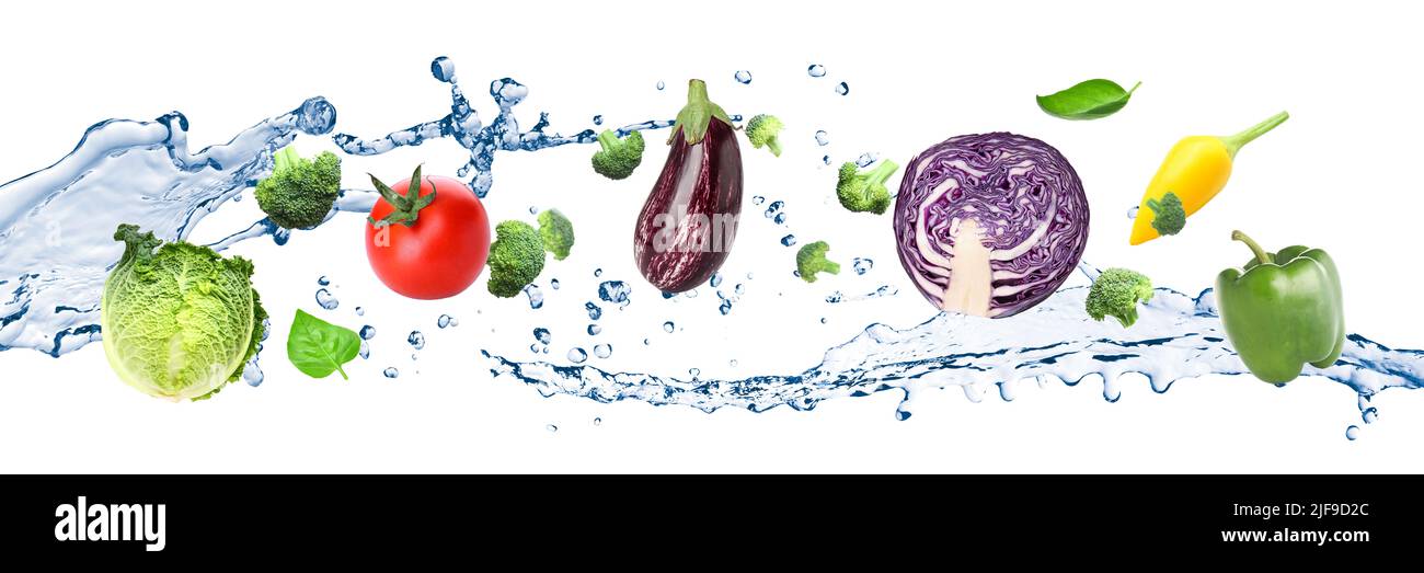 Many flying fresh vegetables with water splashes on white background ...