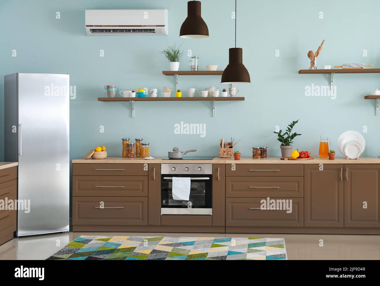 Interior of modern comfortable kitchen with brown furniture and ...
