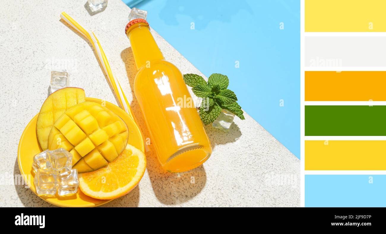 Bottle of cold soda with tropical fruits near swimming pool. Different ...