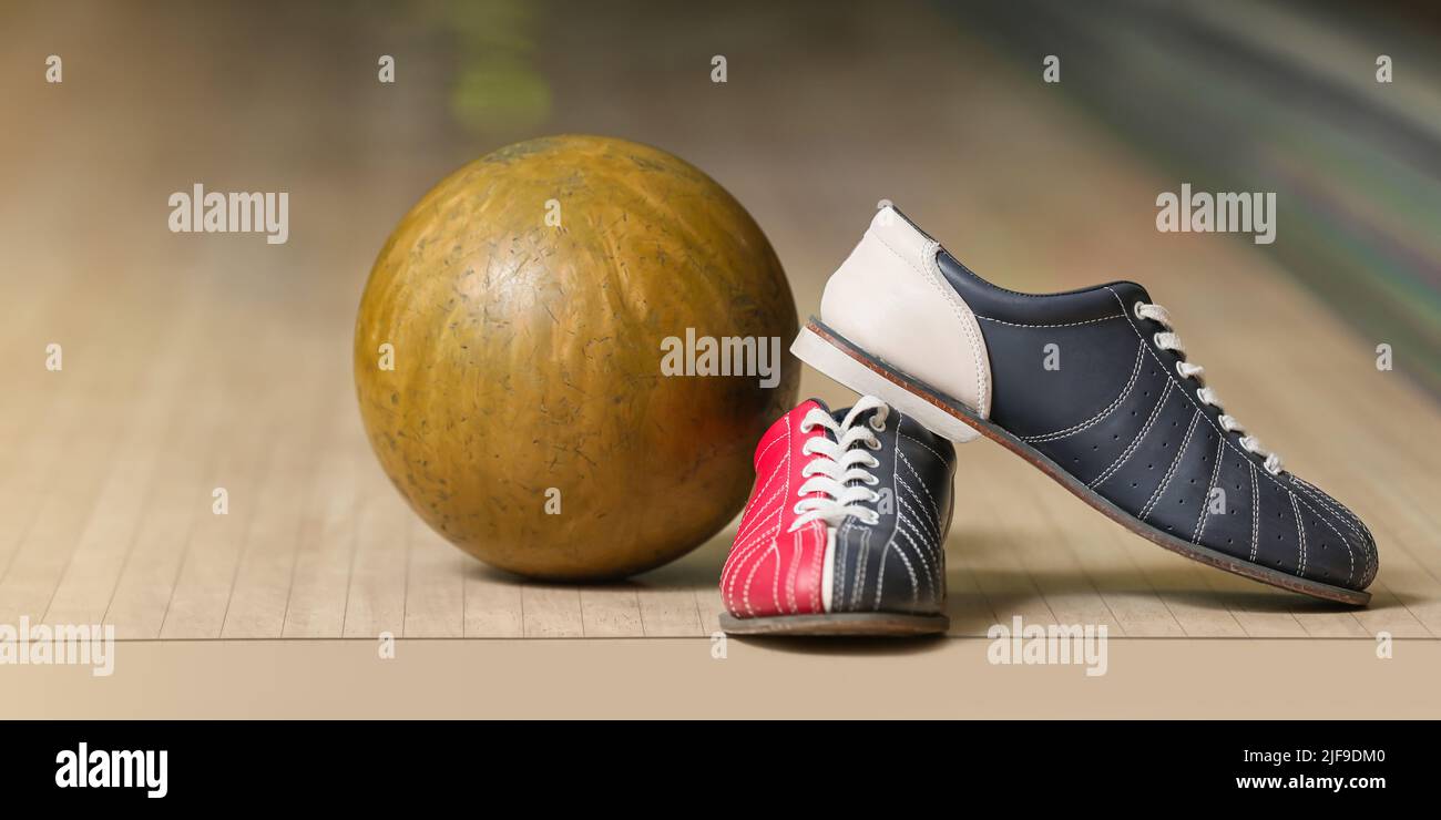Ball and shoes on floor in bowling club Stock Photo - Alamy