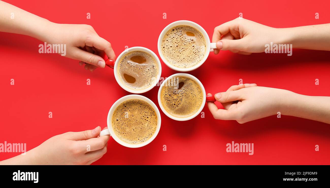 Female hands and cups of coffee on red background, top view Stock Photo ...