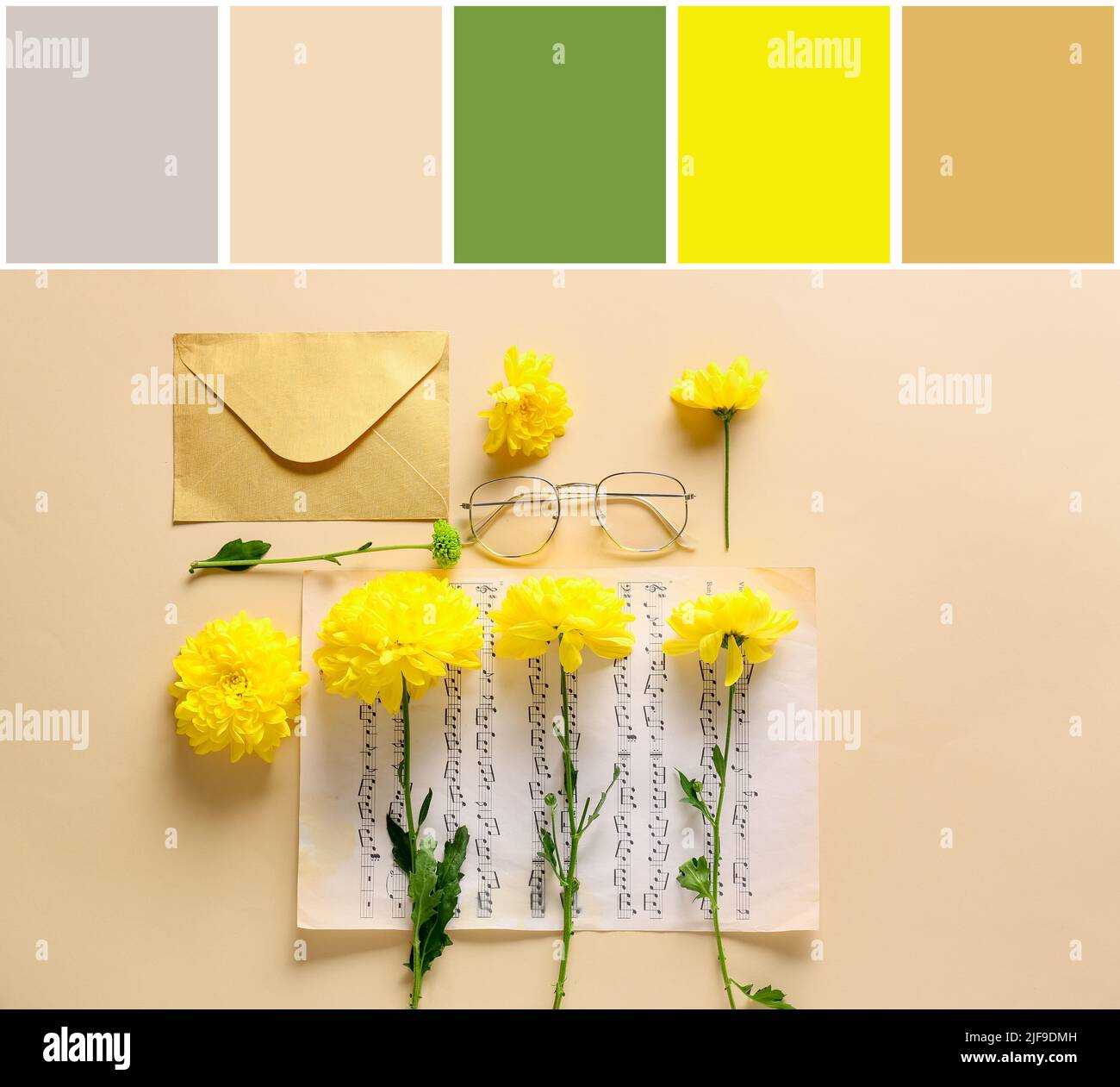 Beautiful composition with flowers, music sheet and envelope on yellow ...