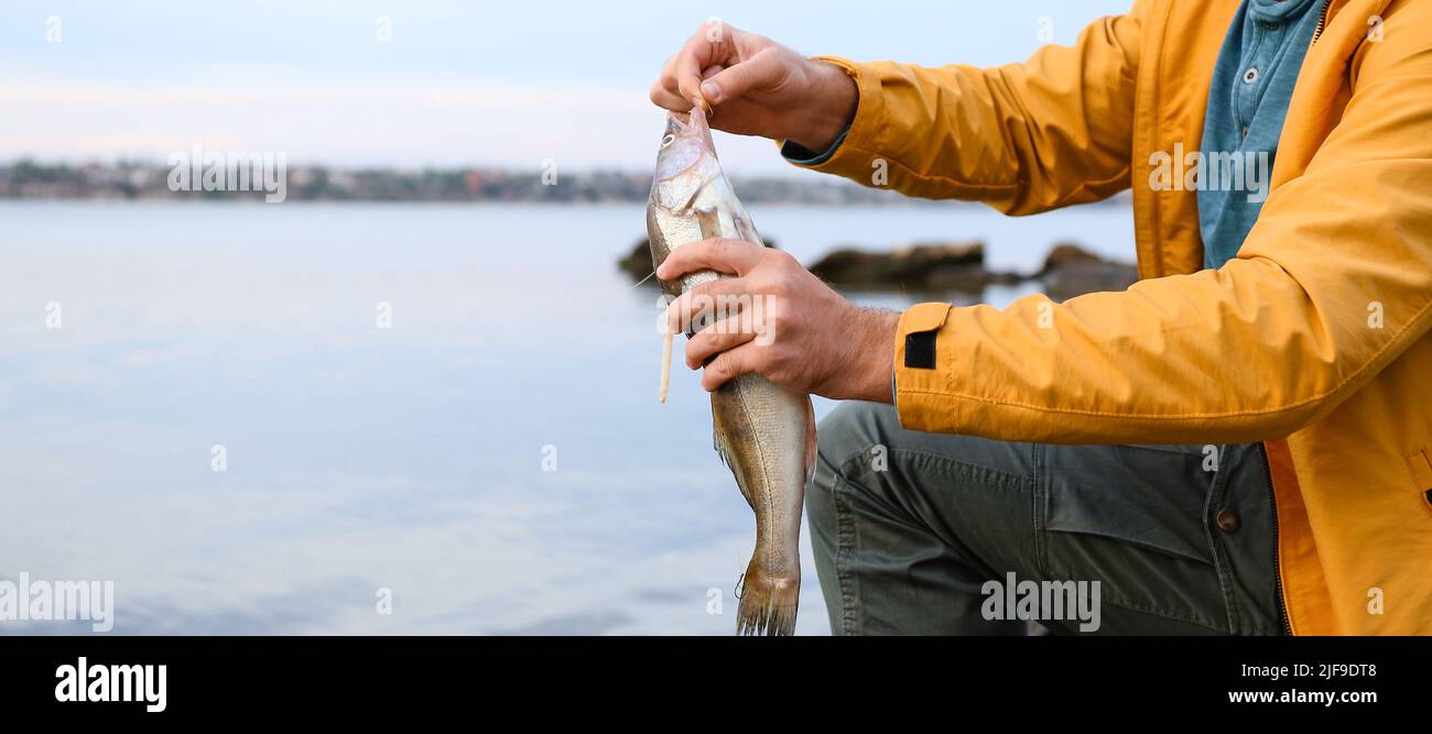 Young man fishing on river Stock Photo - Alamy