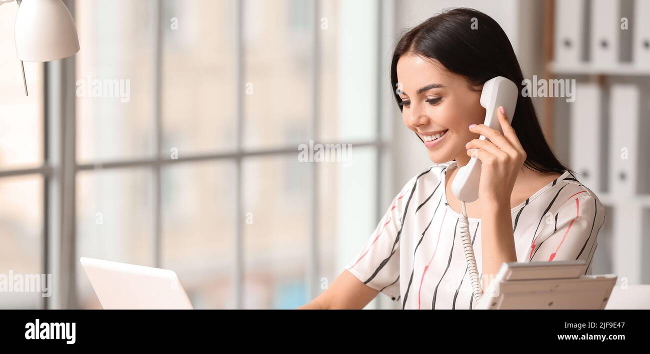 Beautiful young secretary talking by phone in office Stock Photo - Alamy