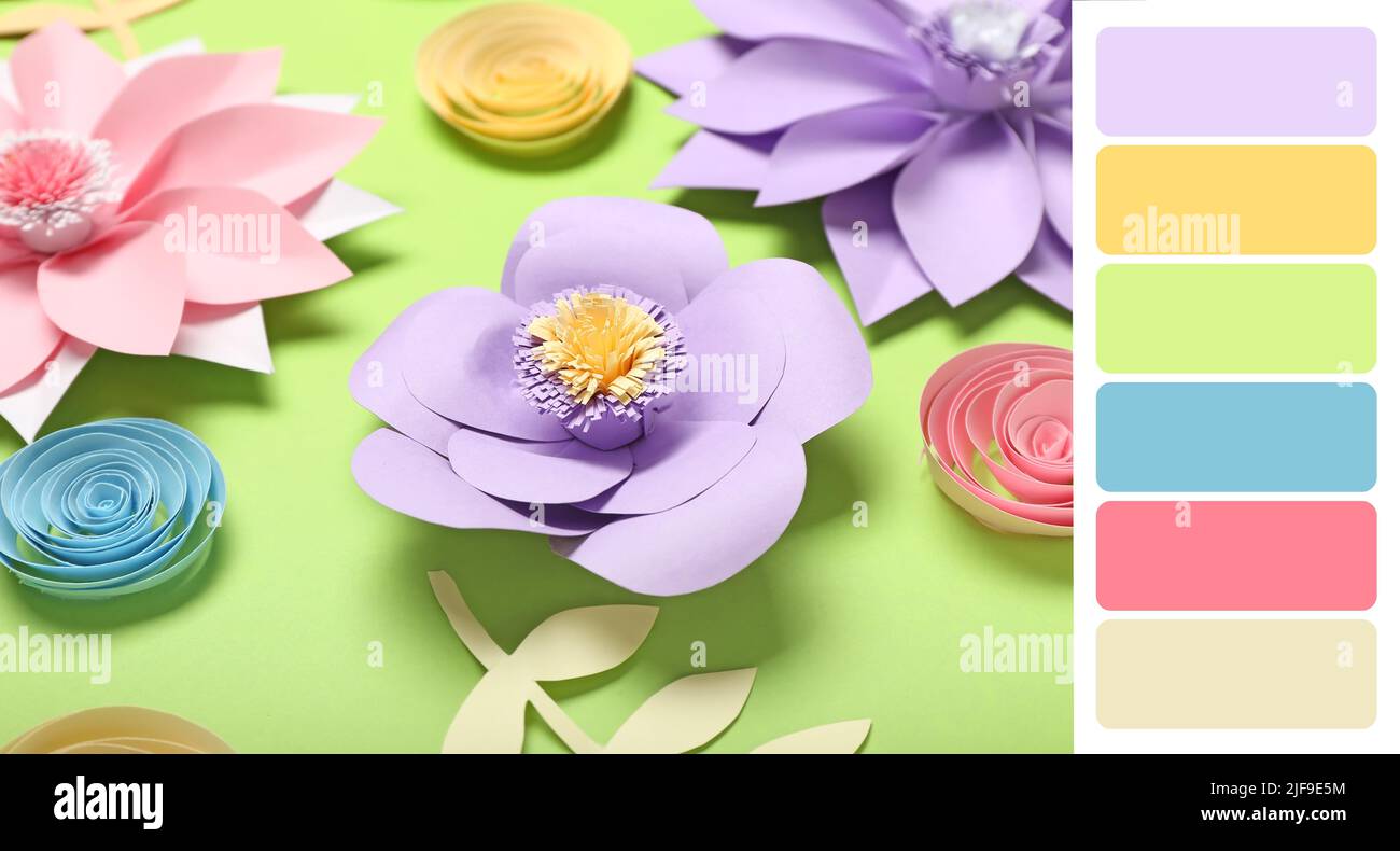 Beautiful handmade paper flowers on green background. Different color ...