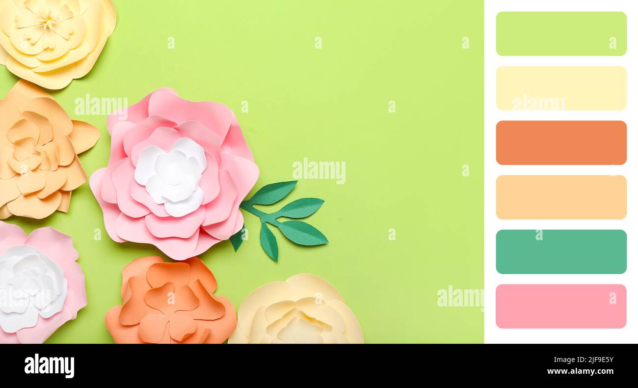 Beautiful handmade paper flowers on green background. Different color ...