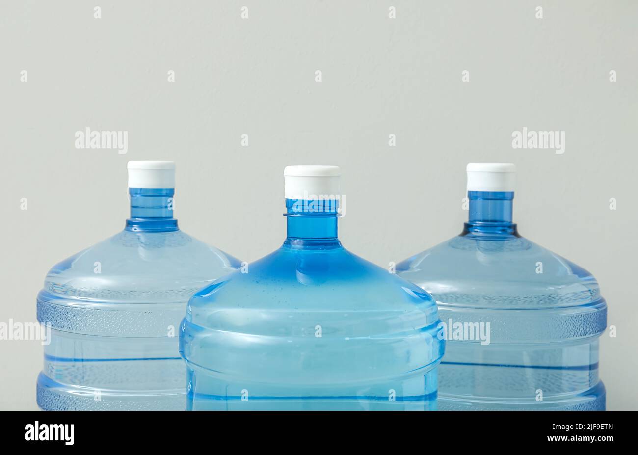 Bottles of clean water on light background Stock Photo - Alamy