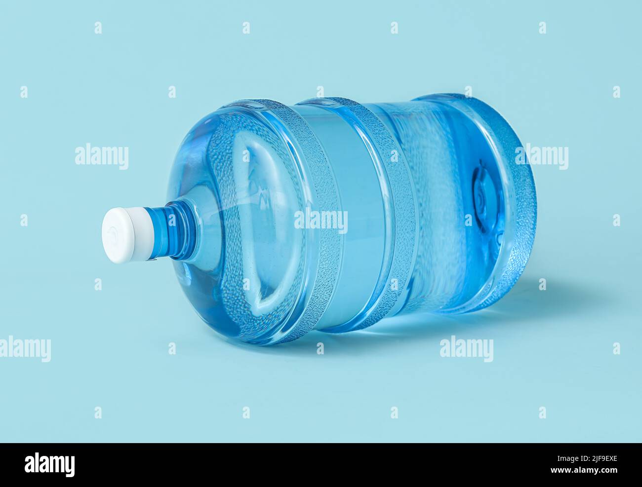 Bottle of clean water on light blue background Stock Photo - Alamy
