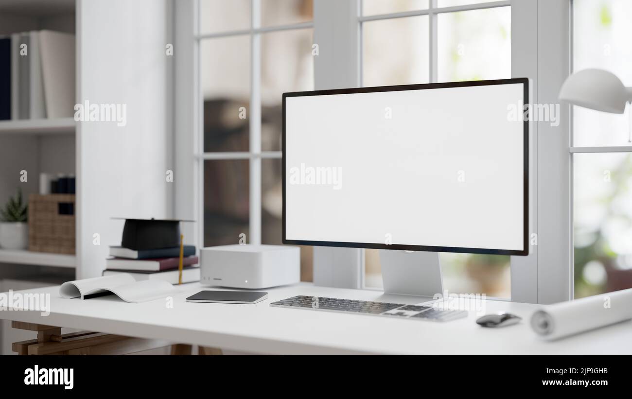 Modern white home office desk against the window with PC desktop ...