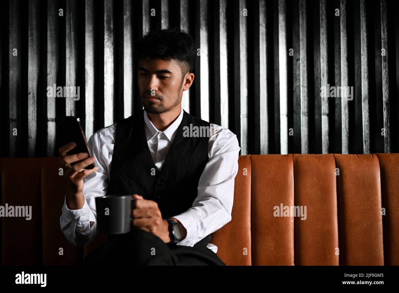 Smart and successful asian businessman or male CEO boss sits at the ...