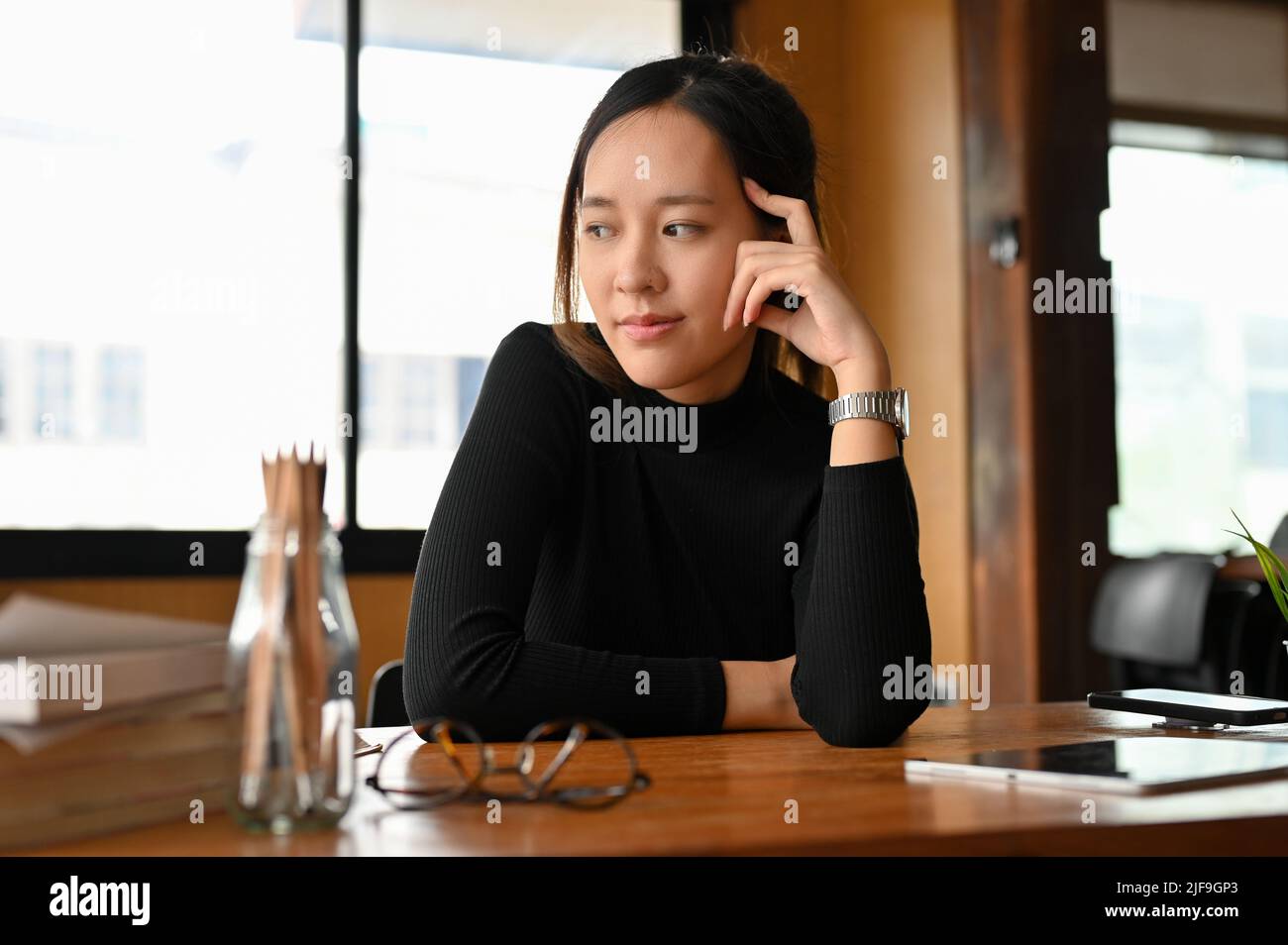 Thoughtful millennial Asian female college student or freelancer ...