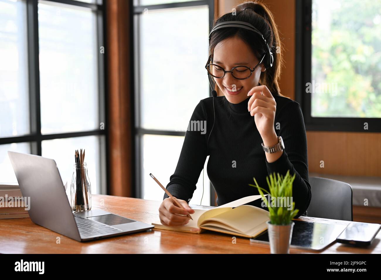 Cheerful and friendly young asian female online freelance tutor or ...