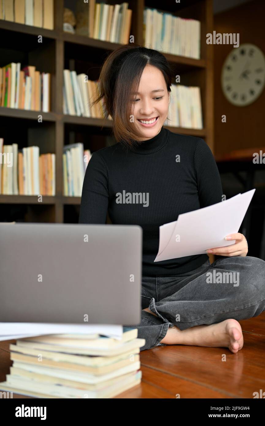 Attractive Asian young female journalist or freelance writer working in ...