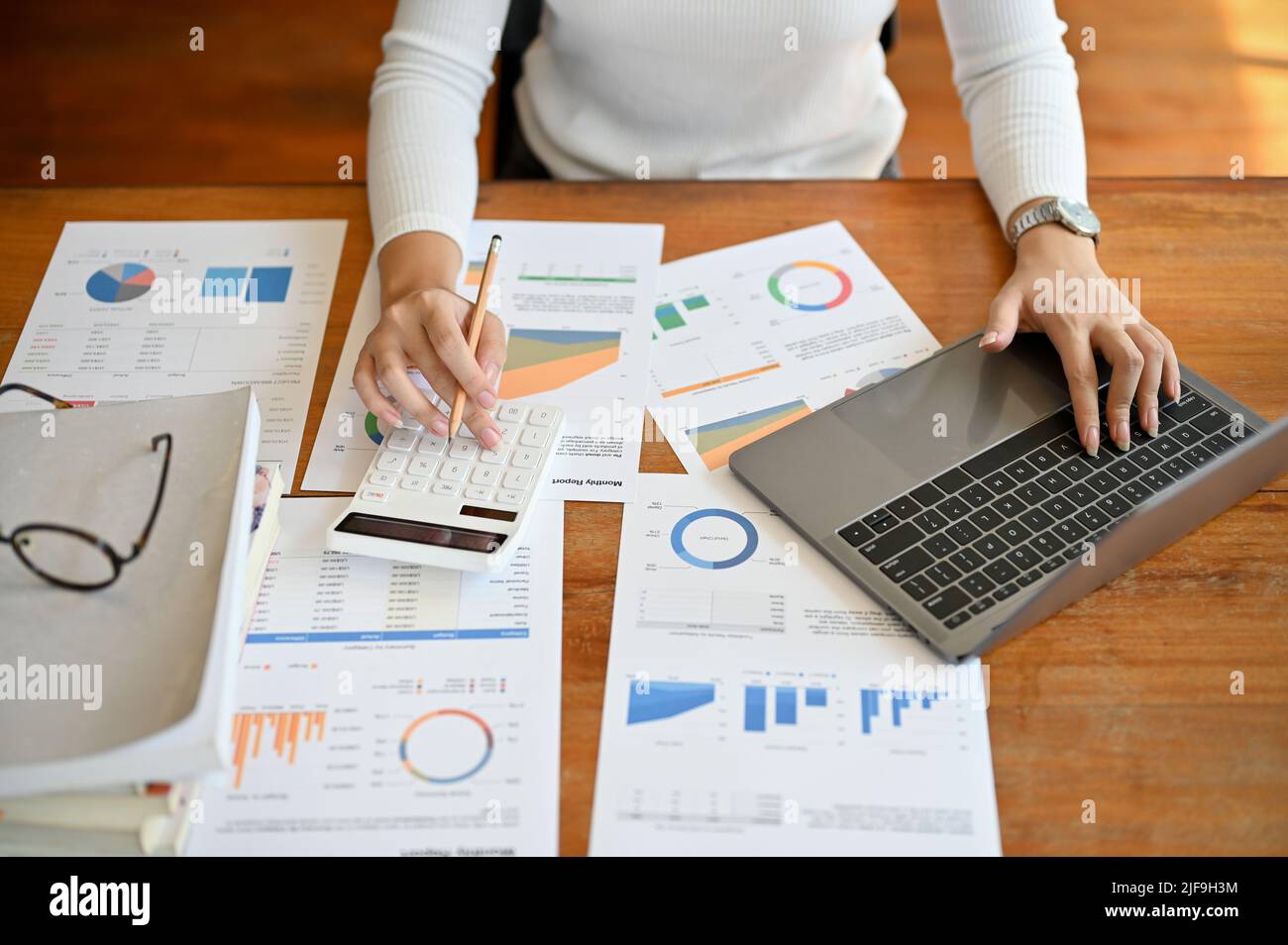 Female accountant or businesswoman working at her desk, calculating ...