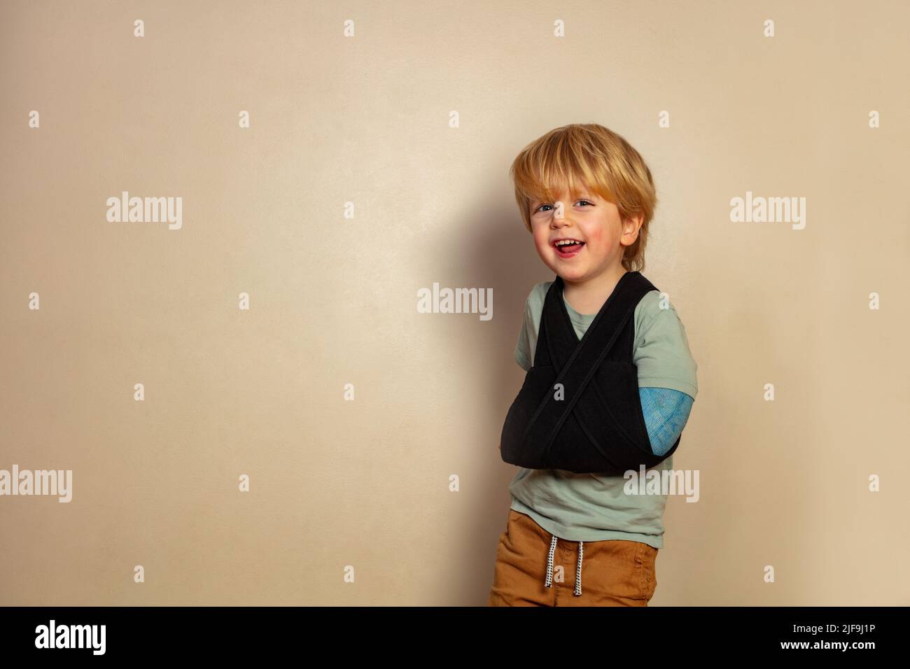 Cute young boy portrait with broken hand in cast after accident Stock ...