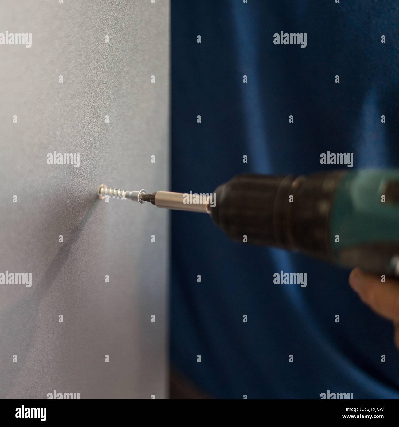 The process of screwing the screw, installing a sliding door wardrobe ...