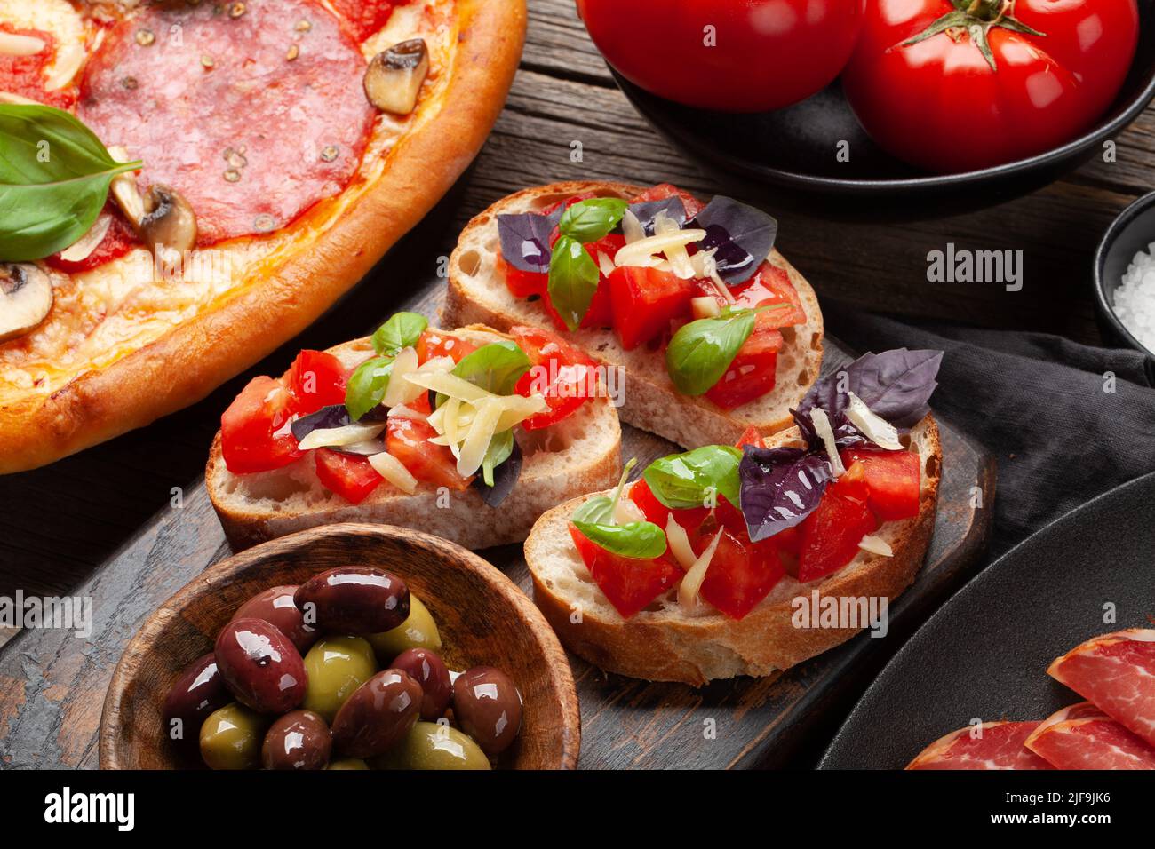 Italian cuisine. Pepperoni pizza and antipasto toasts Stock Photo - Alamy