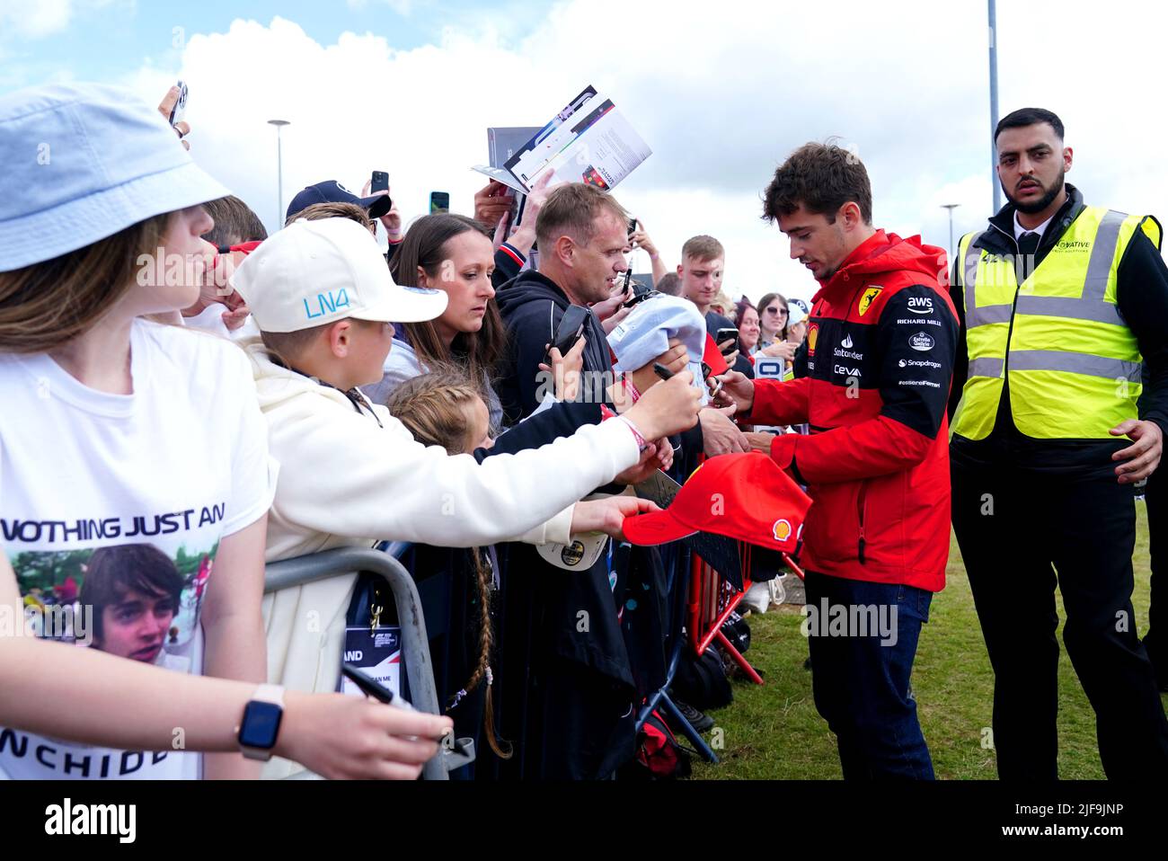 Ferrari's Charles Leclerc signs autographs for fans as he arrives for ...