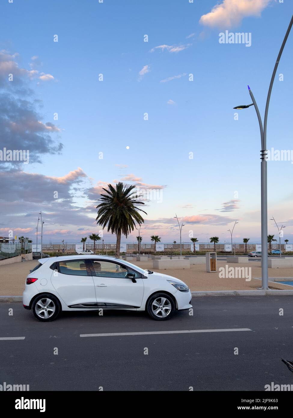 White Clio 4 car driving on the road Stock Photo - Alamy