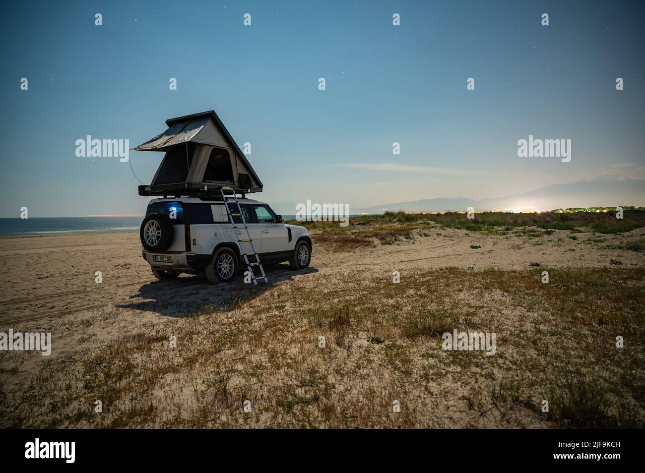 Camping on the beach with 4x4 all terrain vehicle and roof tent ...