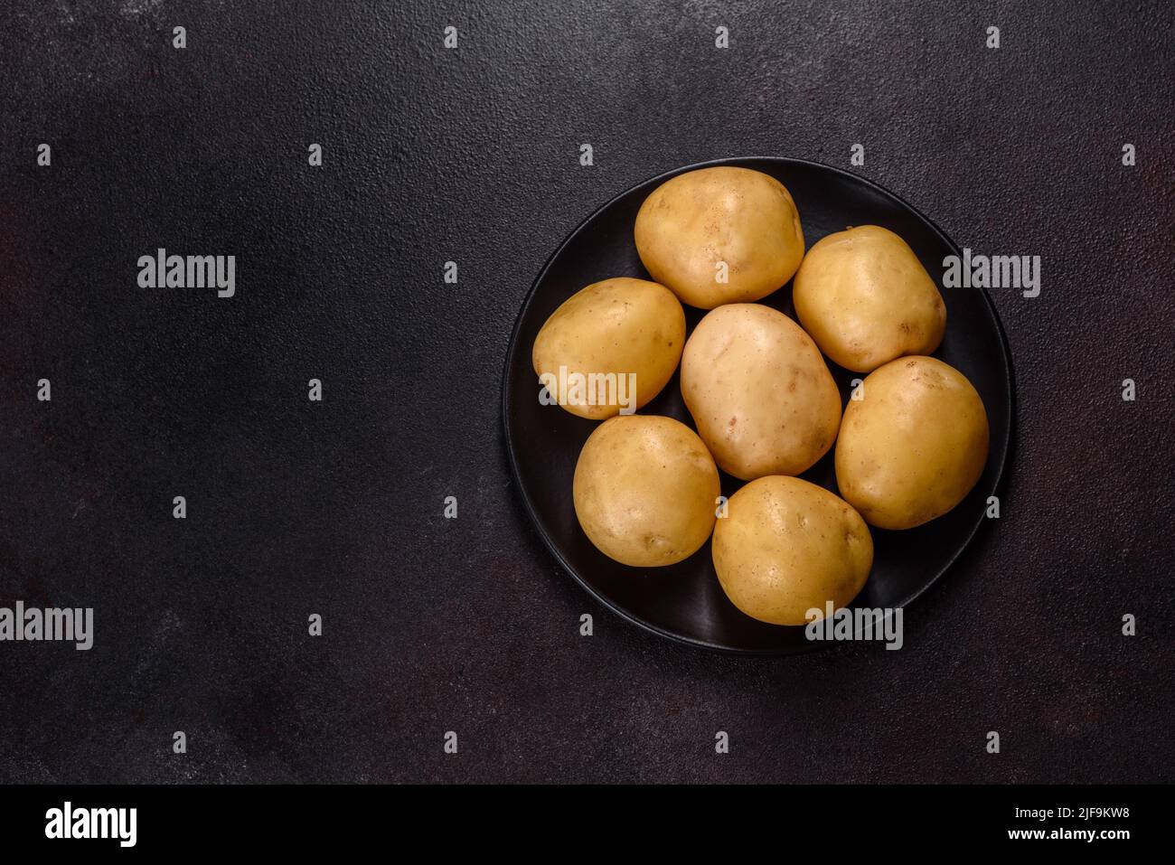 A pile of young potatoes on the table. The benefits of vegetables ...