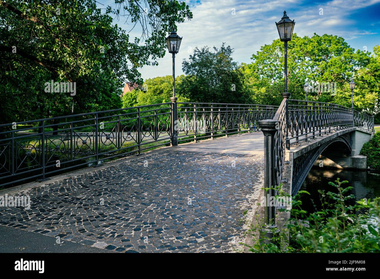 footpath over a footbridge to the park on a sunny overcast day Stock ...