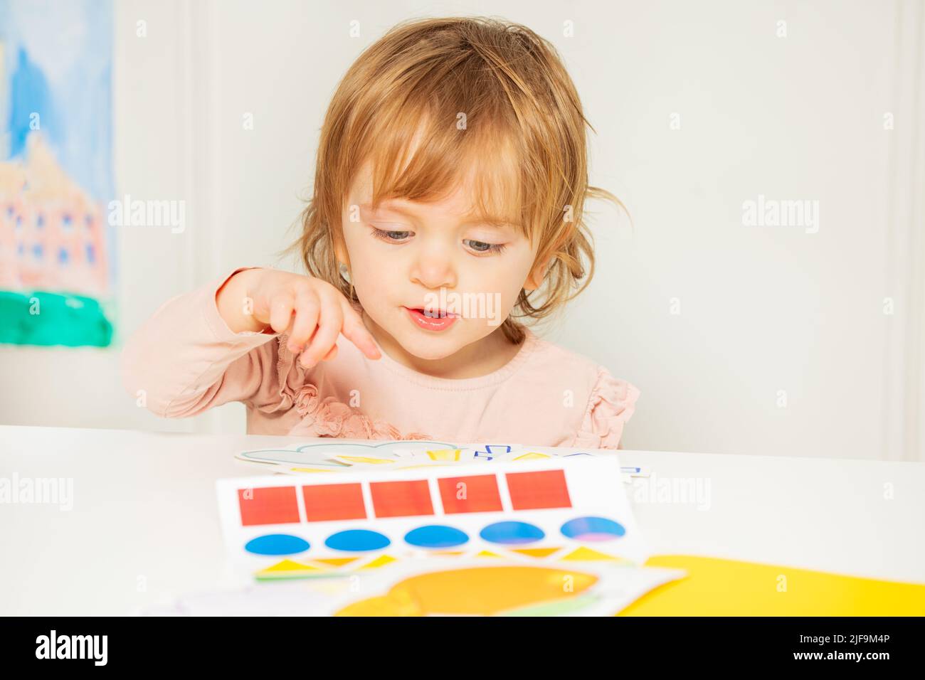 Girl point to shapes during development class in kindergarten Stock ...