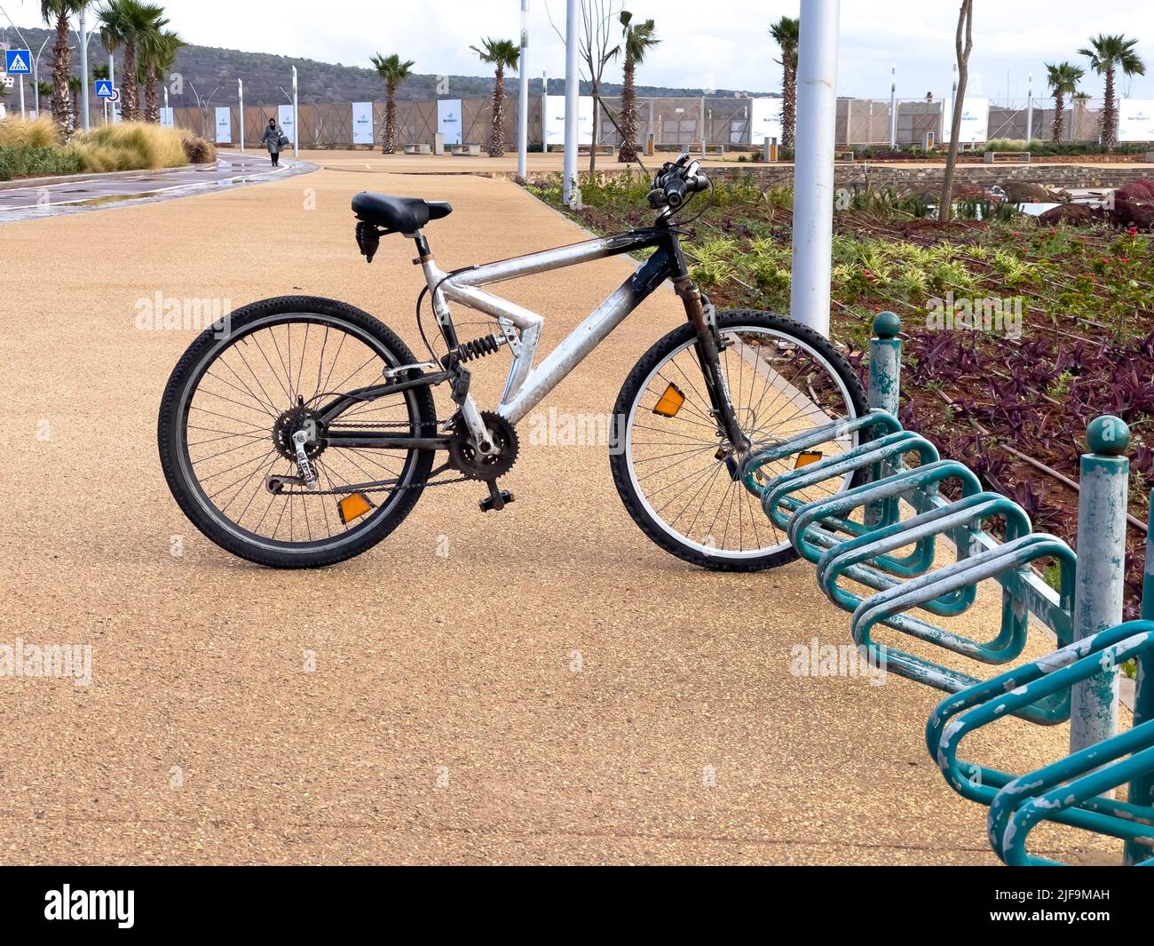 Single bicycle locked on a bike rack in a public space Stock Photo - Alamy
