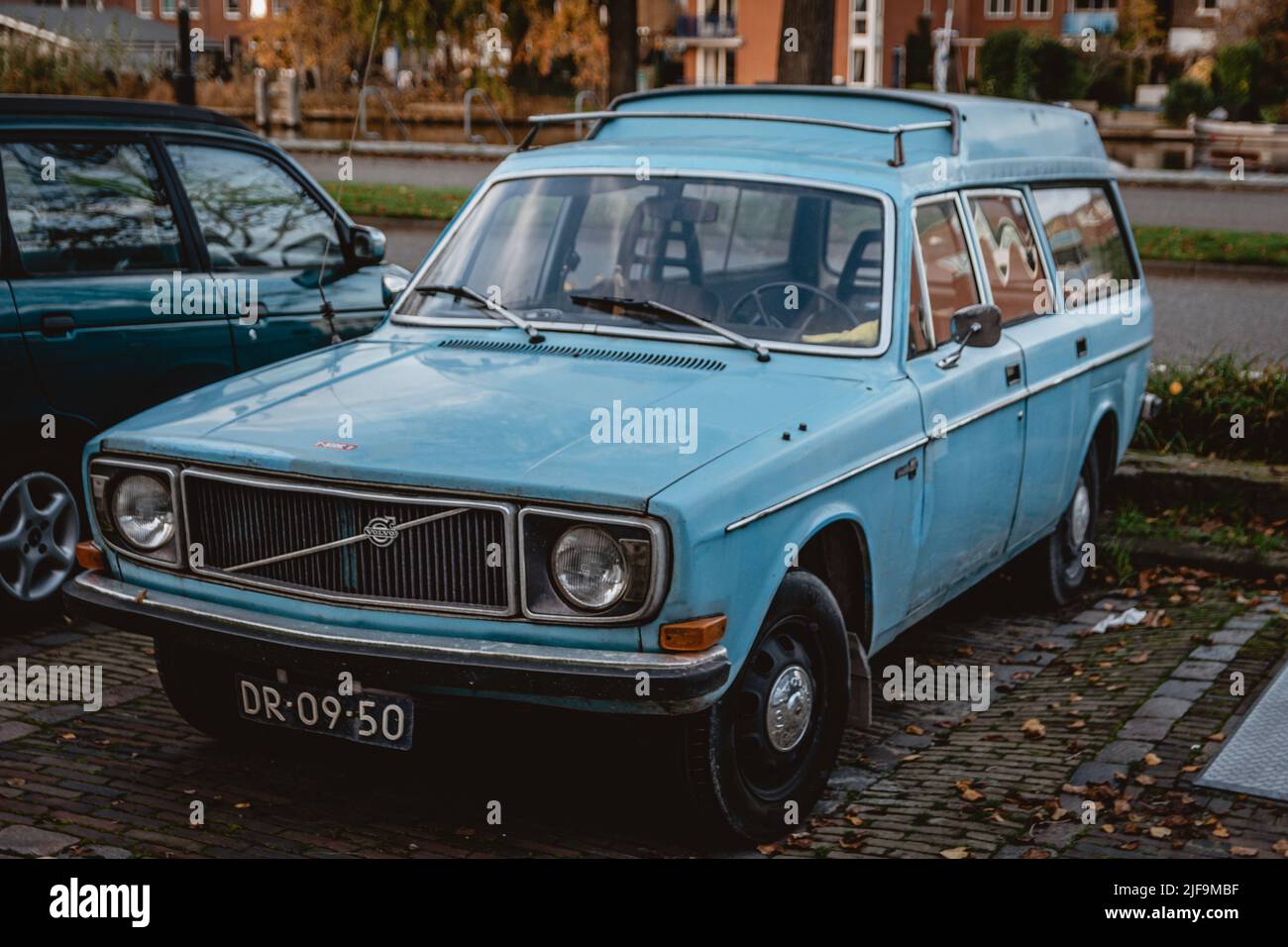 Old and classic blue car parked in the street. Volvo 140 Stock Photo ...
