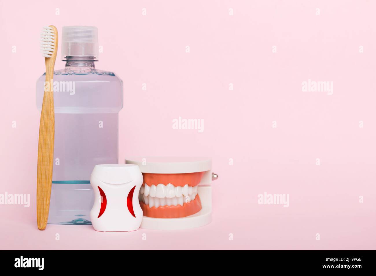 Mouthwash and other oral hygiene products on colored table top view ...