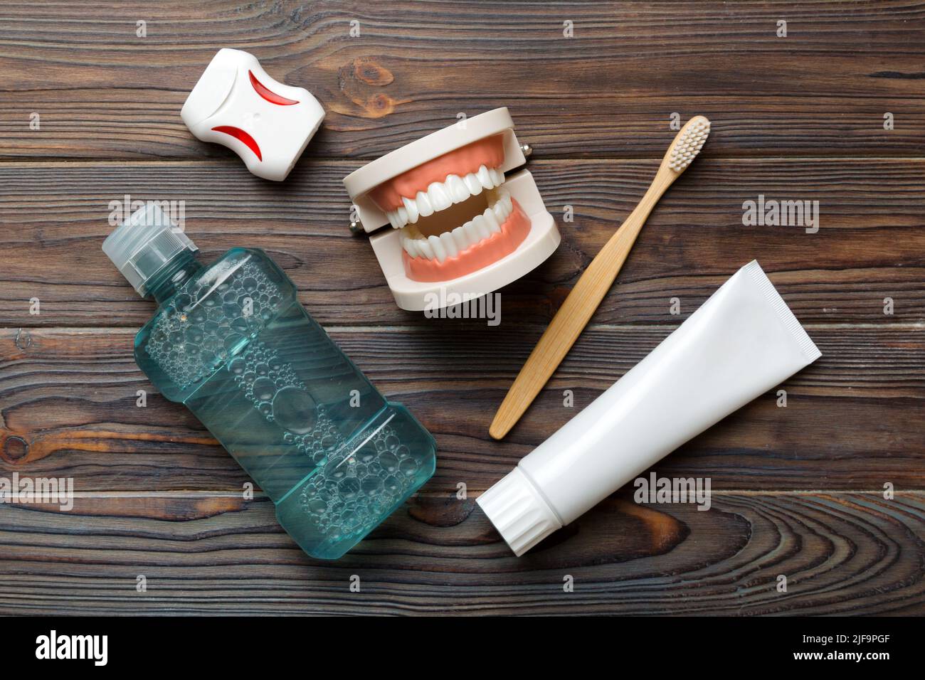 Mouthwash and other oral hygiene products on colored table top view ...