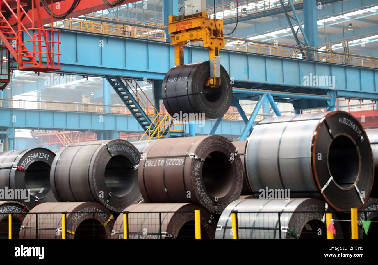RIZHAO, CHINA - JUNE 30, 2022 - Workers hoist steel coils at a workshop ...