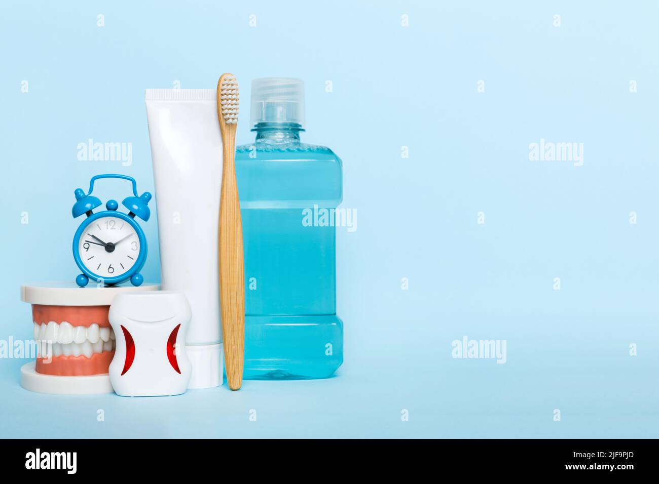 Mouthwash and other oral hygiene products on colored table top view ...