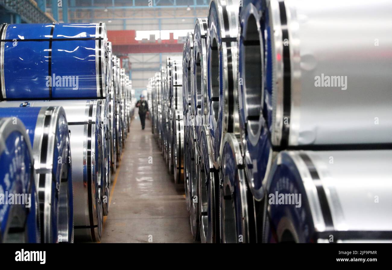RIZHAO, CHINA - JUNE 30, 2022 - A worker looks at steel coils at a ...
