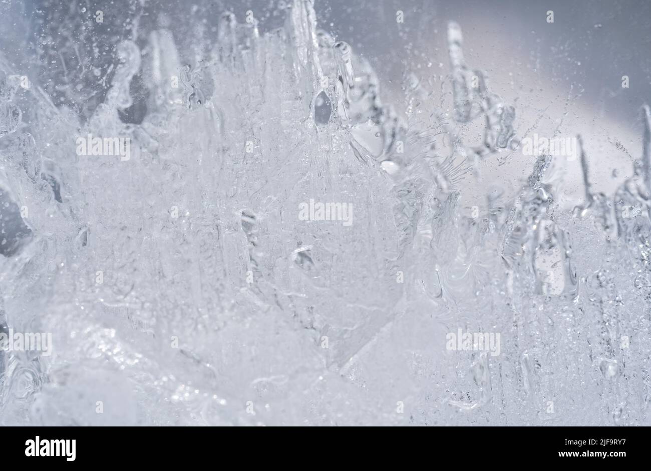 Macro photo of transparent light blue ice of frozen Baikal lake with ...