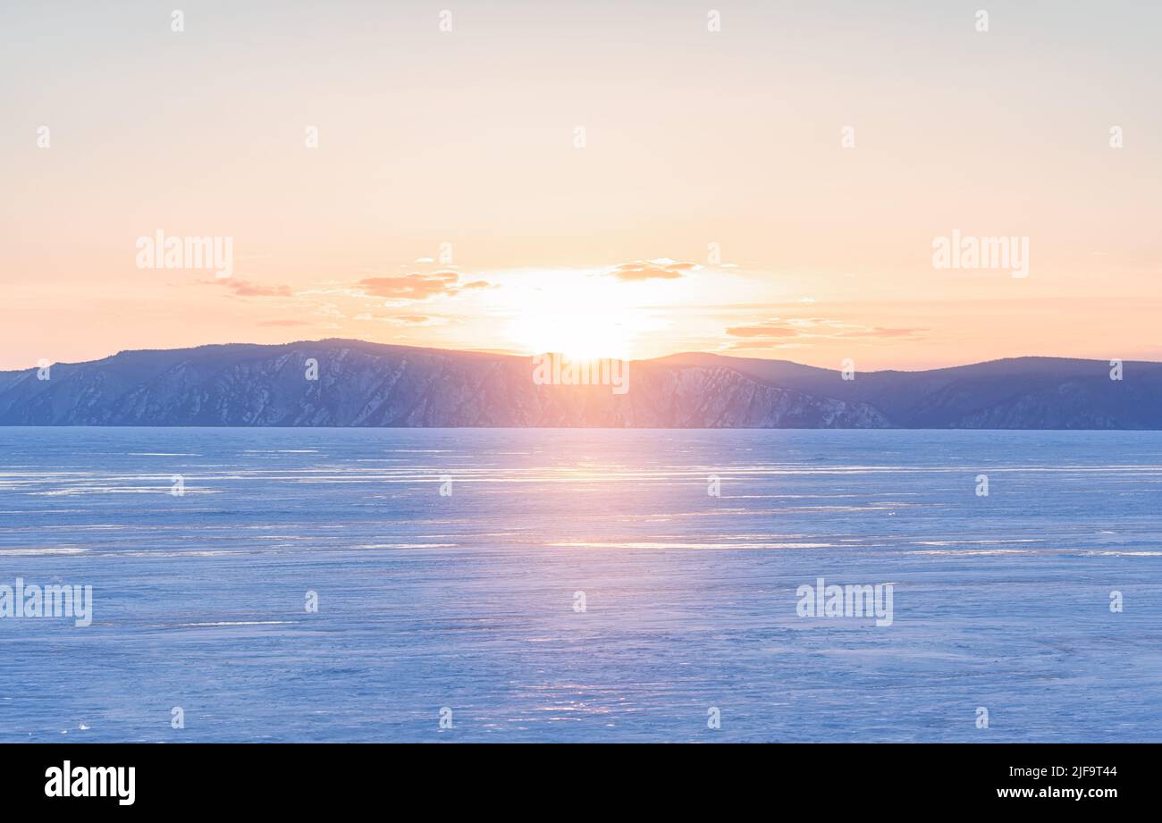 Winter landscape with mountains and Lake Baikal in Siberia at sunset ...