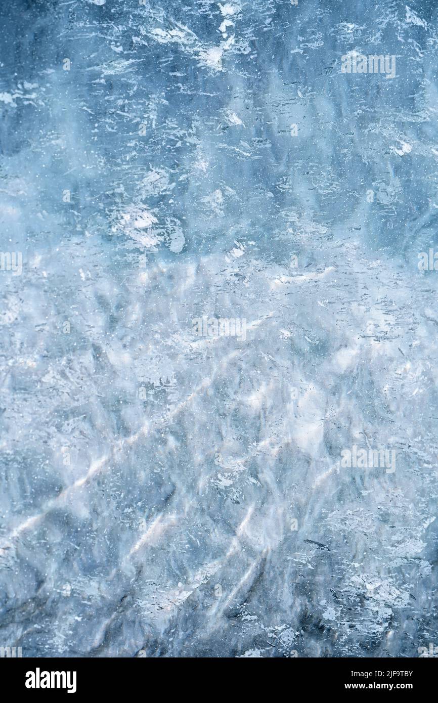 Transparent blue ice of frozen Baikal lake with waves pattern ...