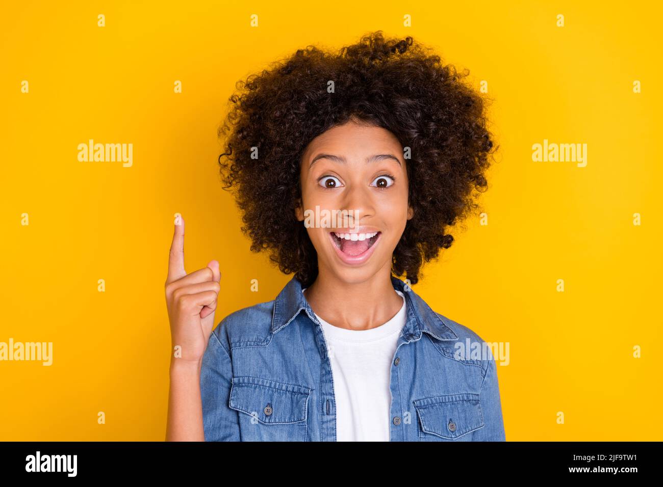 Portrait of attractive cheerful brainy clever preteen girl pointing up ...