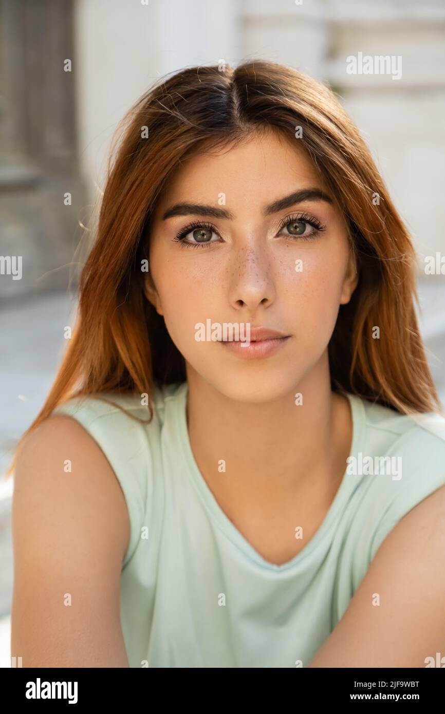 portrait of charming european woman with freckles looking at camera ...