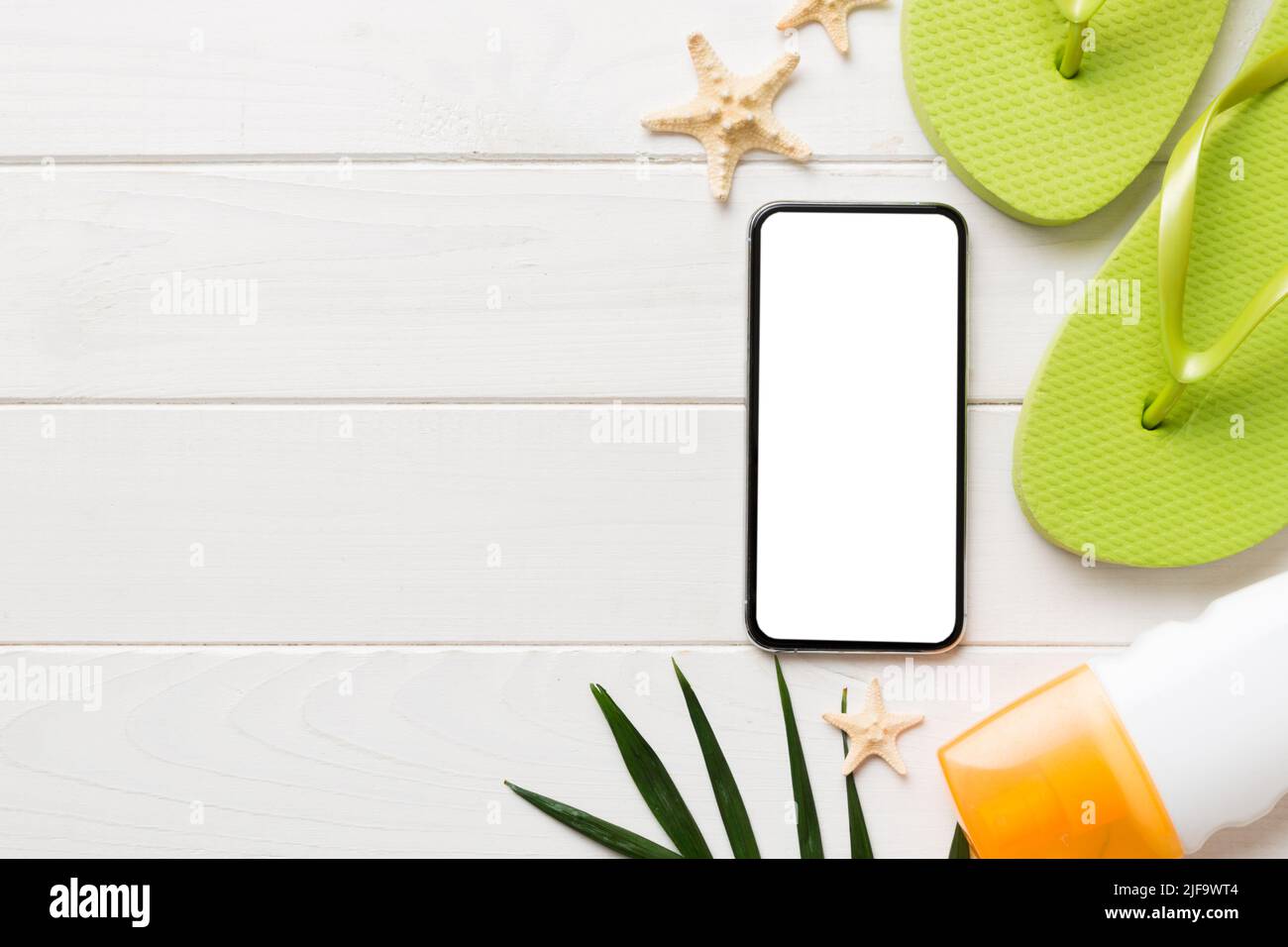 Flat lay composition with Phone and beach accessories on colored ...