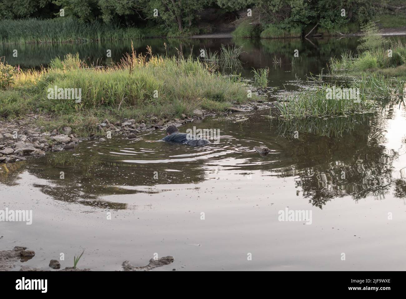 Dead man lying in water hi-res stock photography and images - Alamy
