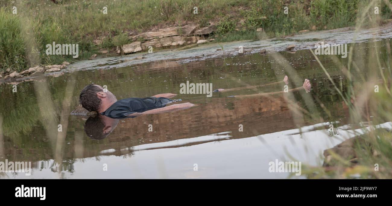 Dead man lying in water hi-res stock photography and images - Alamy