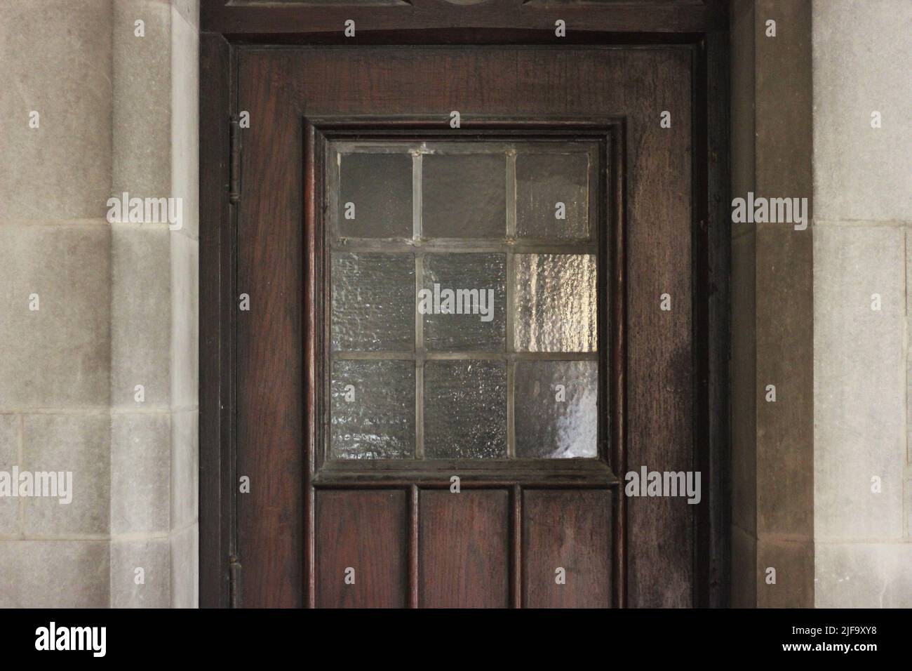 Vintage Gothic wooden door with a window grid of leaded window panes ...