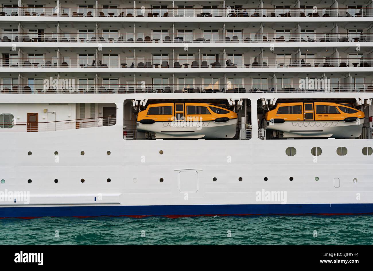 Cruise ship board with deck balconies and lifeboats Stock Photo - Alamy