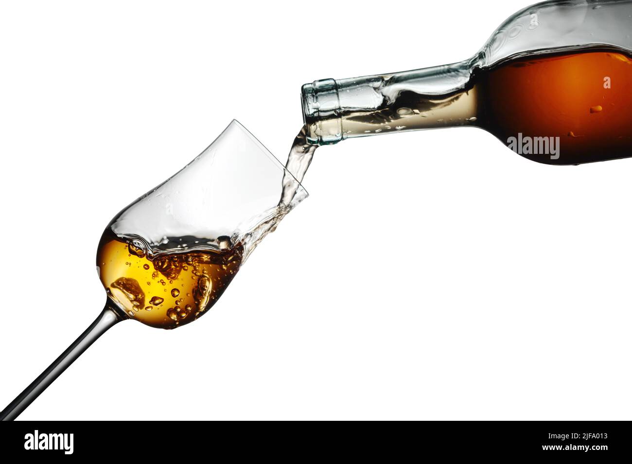 Digestive tulip of premium alcohol. The drink is poured from a bottle ...