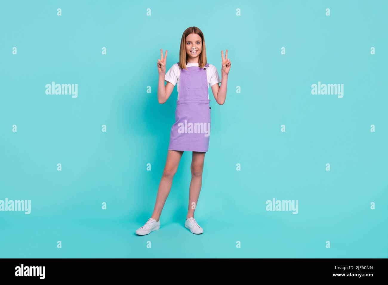 Full body photo of lovely cheerful girl hands fingers demonstrate v ...